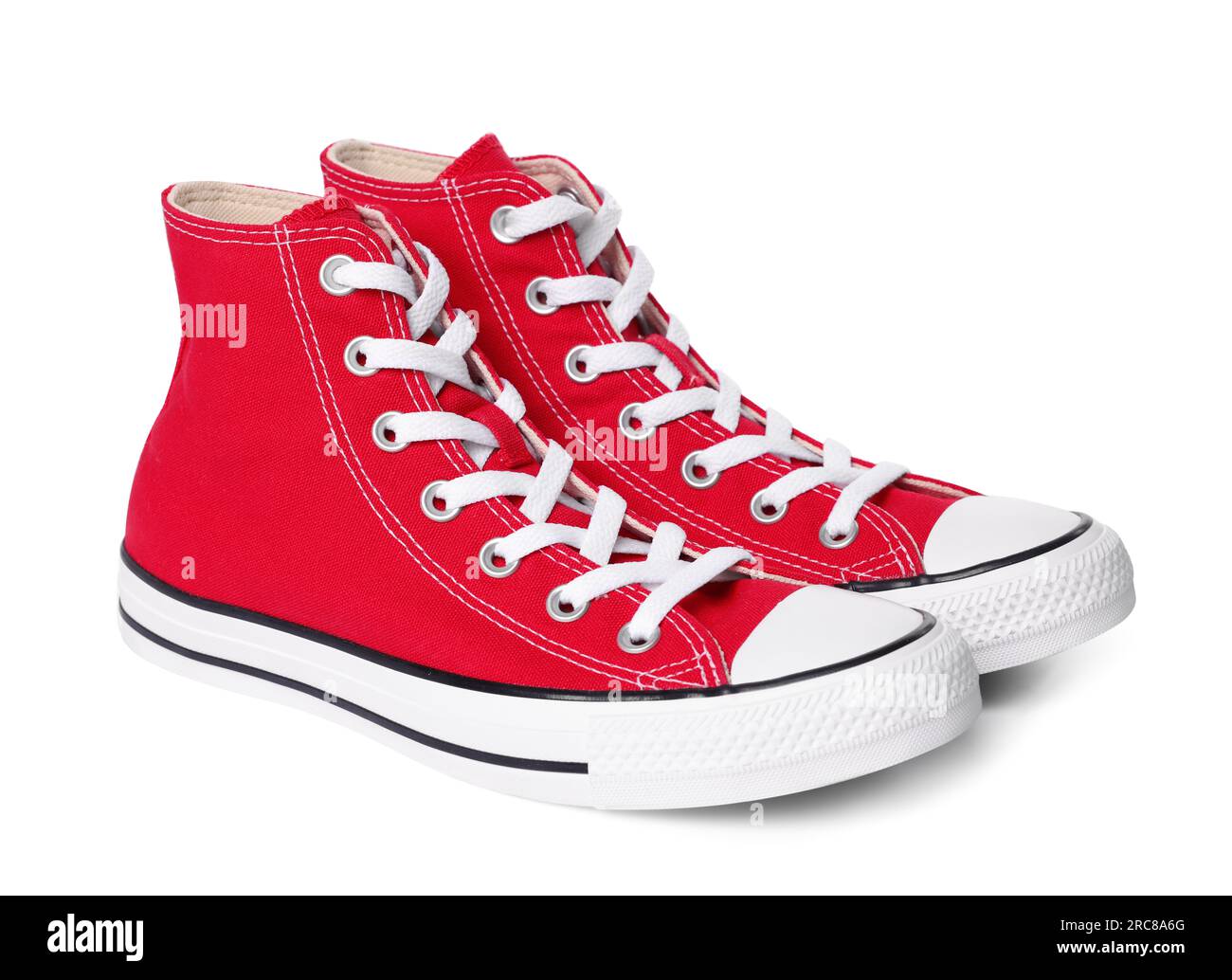 Pair of new red stylish high top plimsolls on white background Stock ...