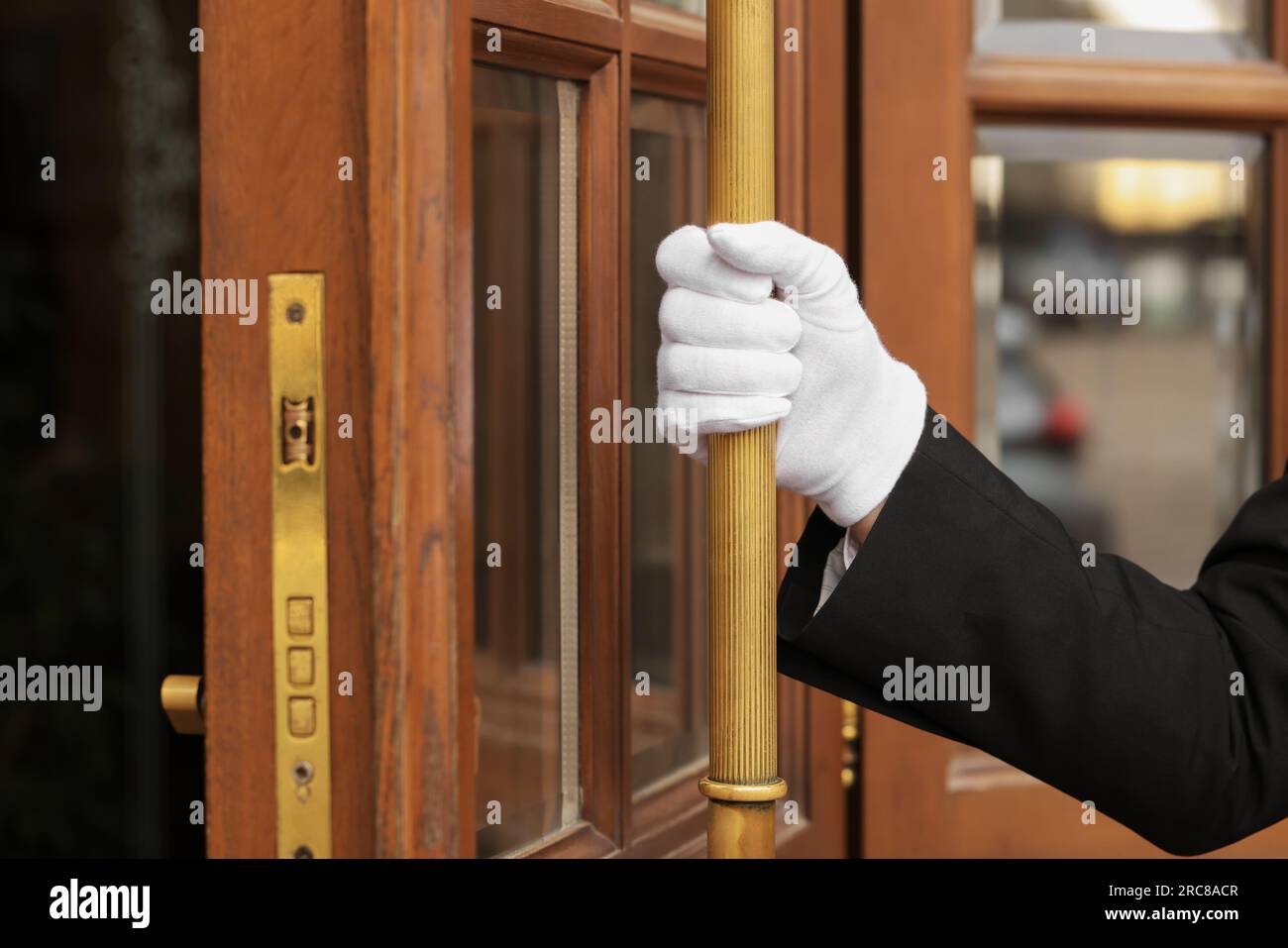 Butler opening the hotel door hi-res stock photography and images - Alamy