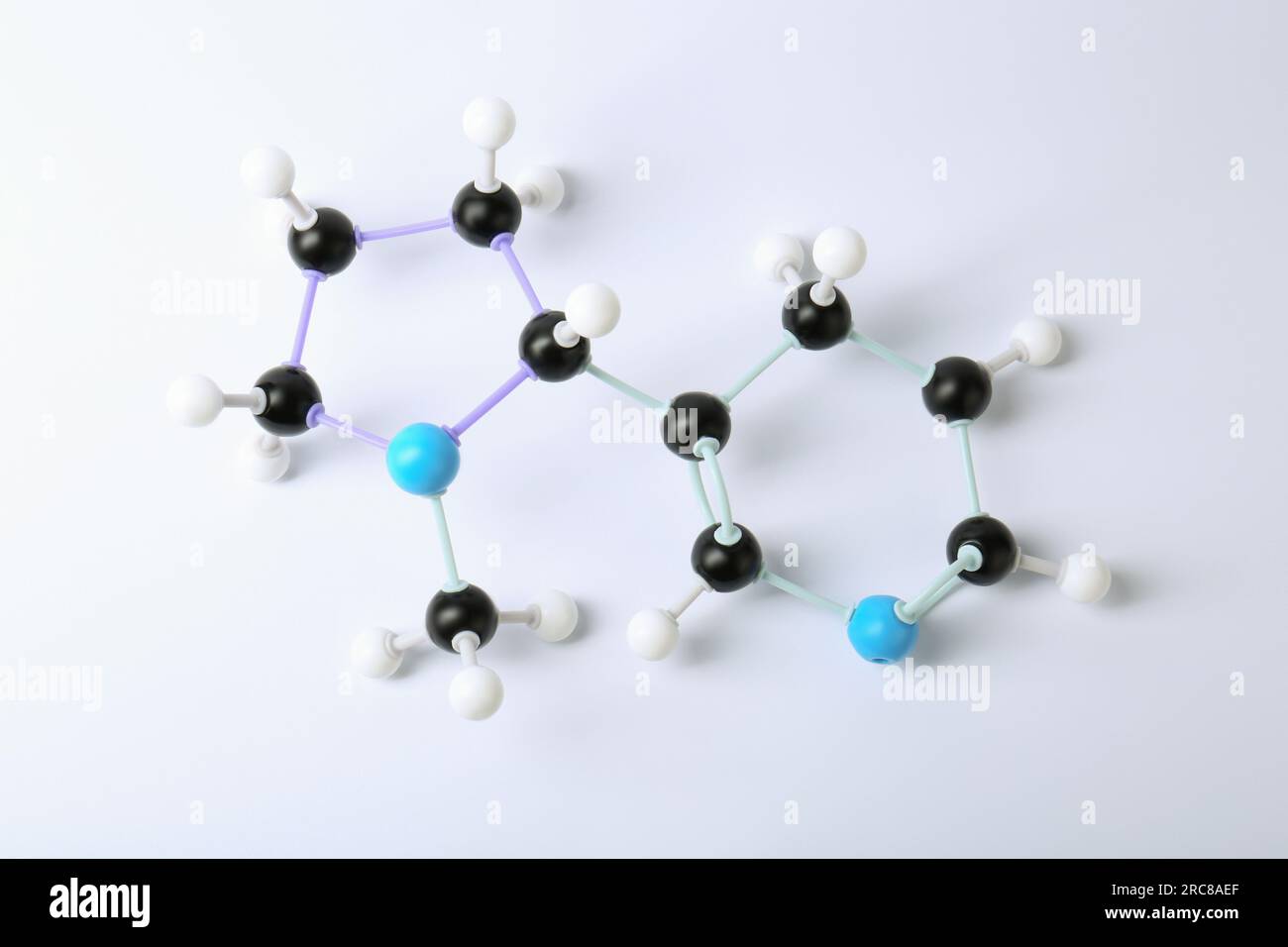 Molecule of nicotine on white background, top view. Chemical model ...