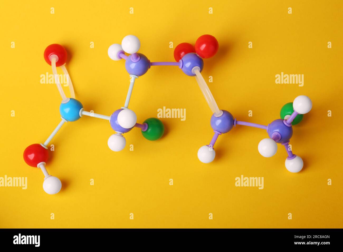 Structure of molecule on yellow background, top view. Chemical model ...