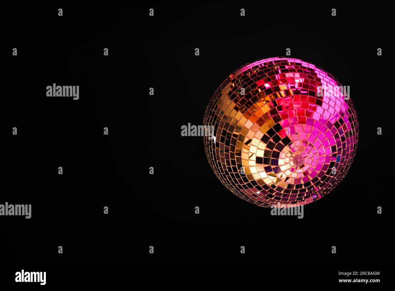 Shiny disco ball hanging on dark ceiling, bottom view Stock Photo - Alamy