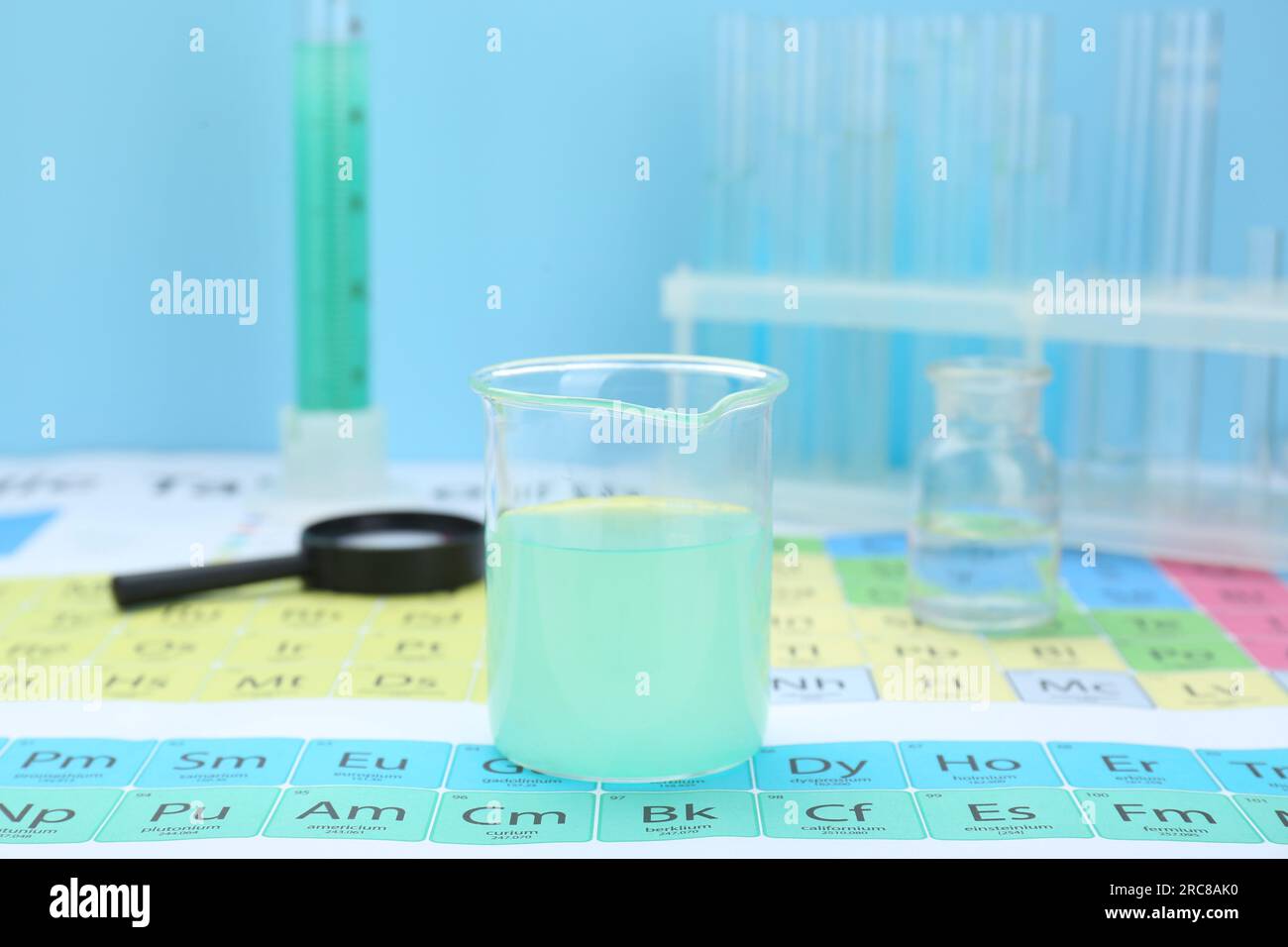 Beaker on periodic table of chemical elements, closeup Stock Photo - Alamy