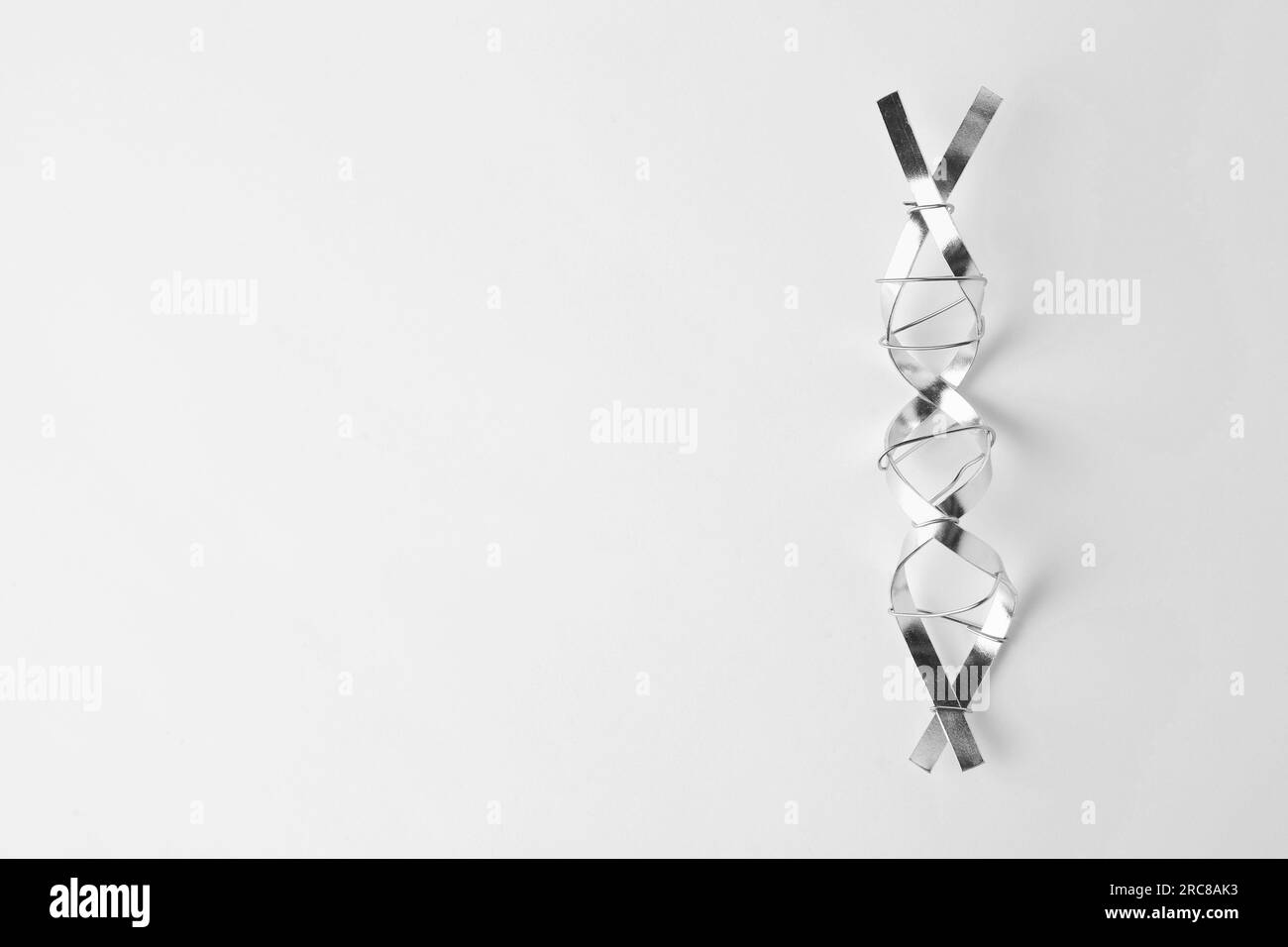 DNA molecular chain model made of metal on white background, top view ...