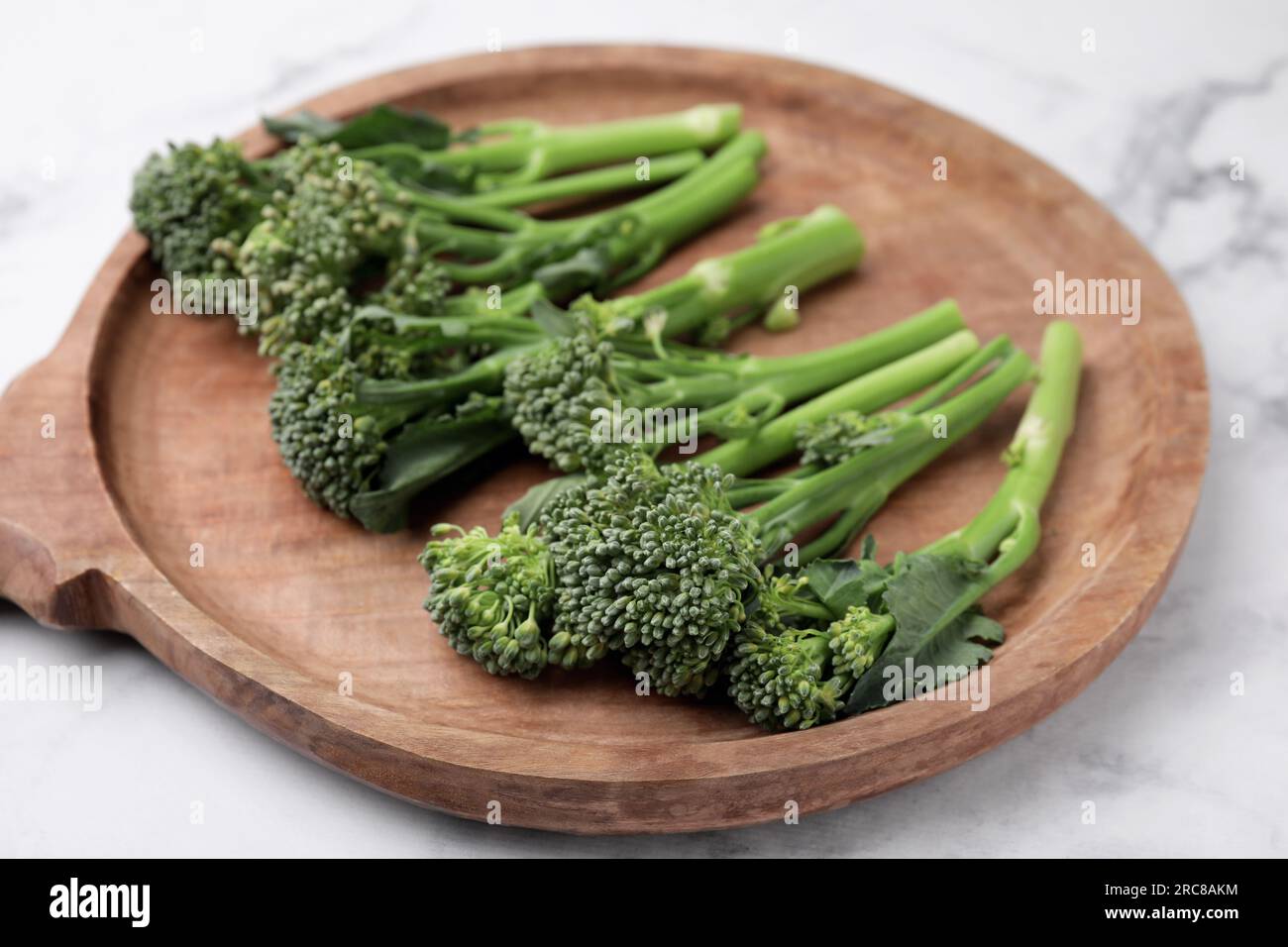 Fresh raw broccolini on white marble table, closeup. Healthy food Stock ...