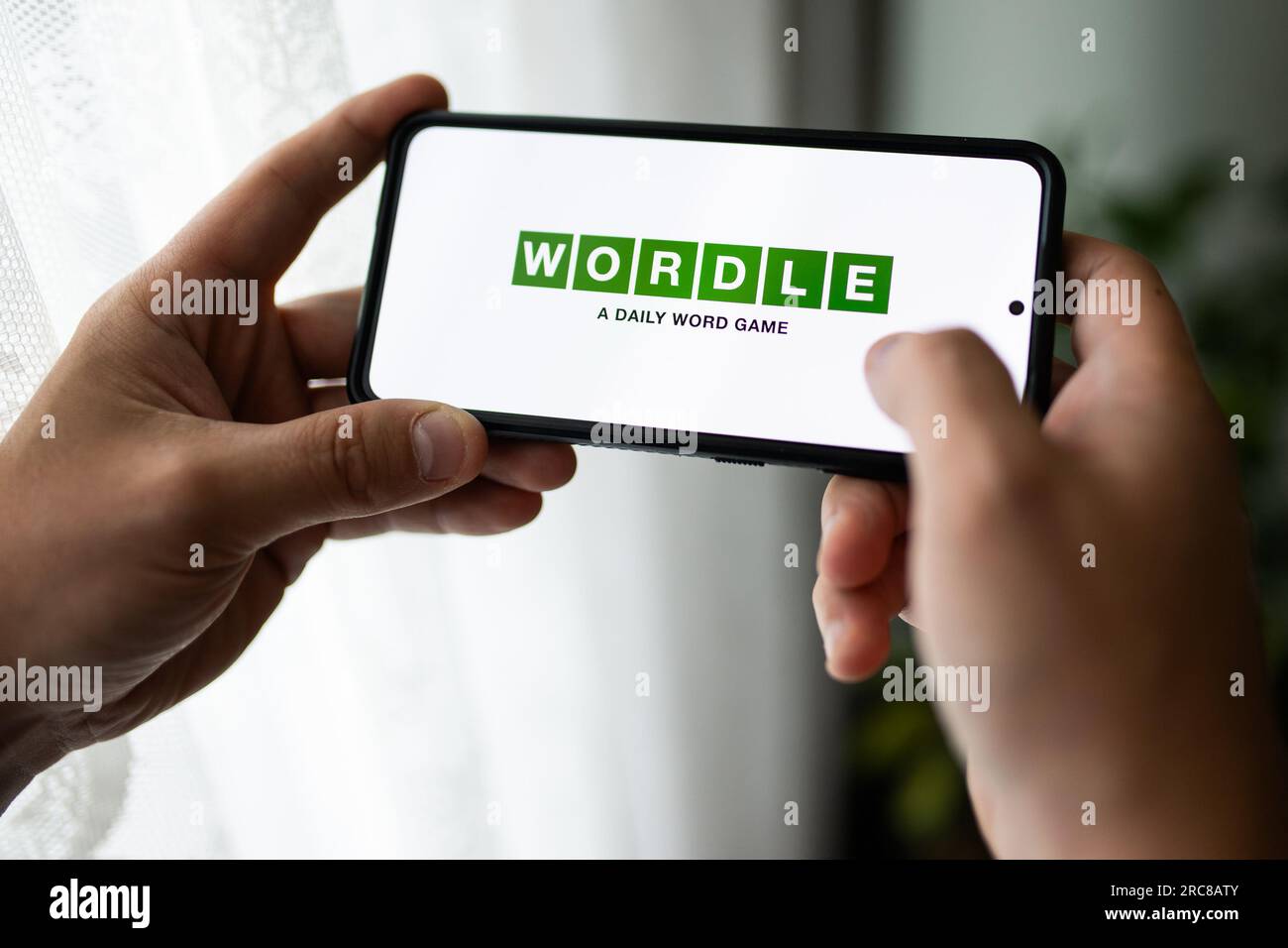 In this photo illustration a Wordle logo seen displayed on a smartphone ...