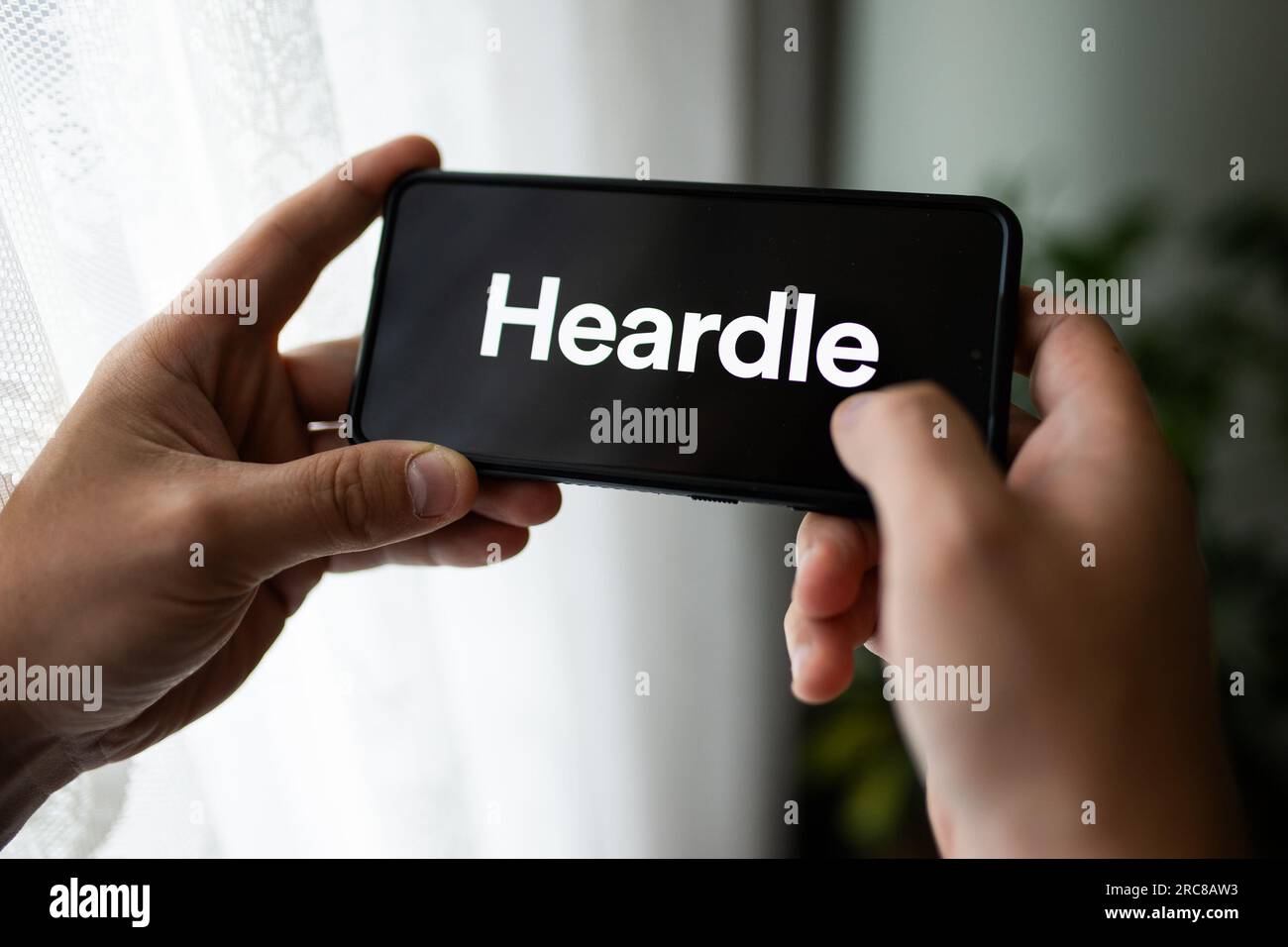 In this photo illustration a Heardle logo seen displayed on a smartphone Stock Photo - Alamy
