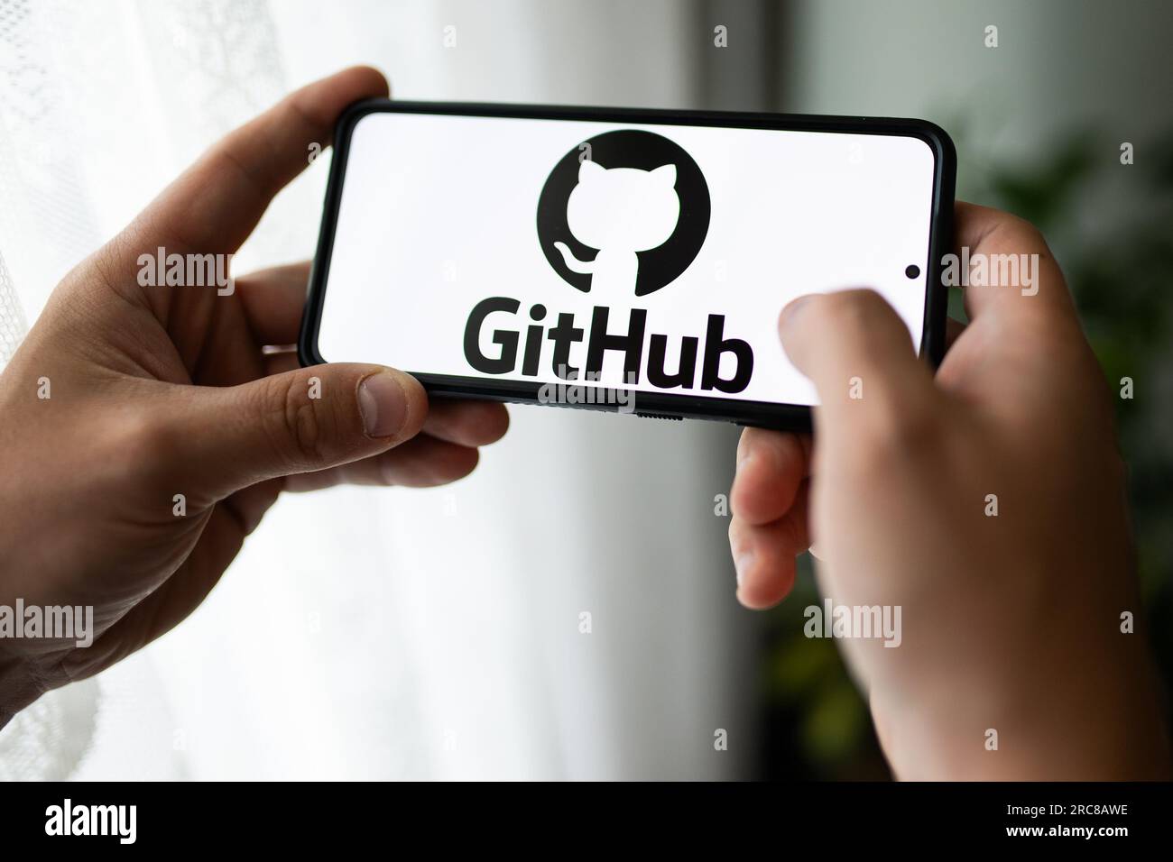 In this photo illustration a GitHub logo seen displayed on a smartphone ...