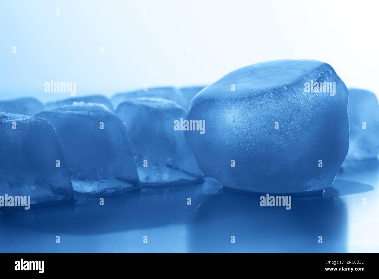 Crystal clear ice cubes on light blue background, closeup. Color tone effect Stock Photo - Alamy
