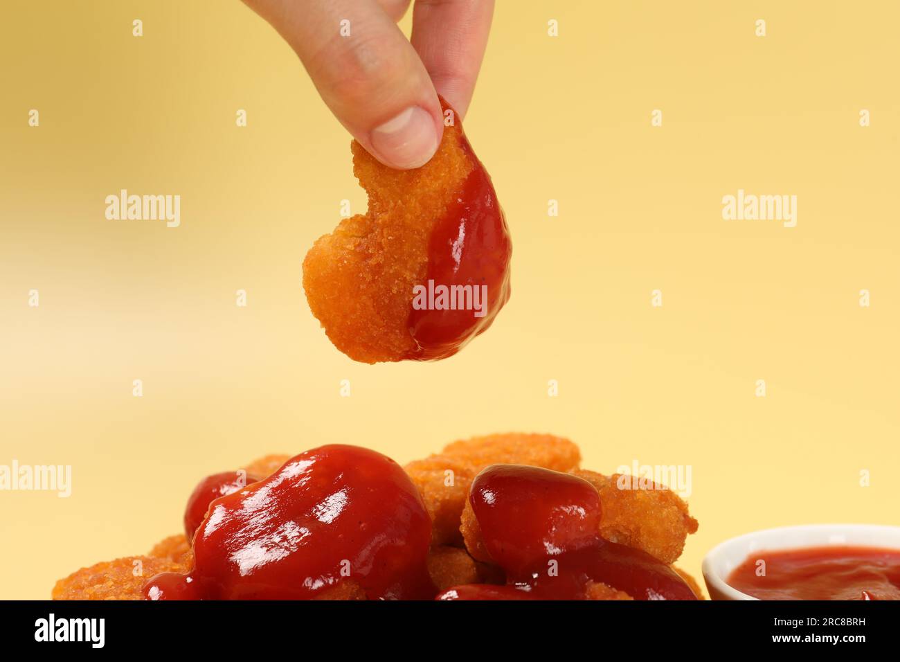 Person eating chicken nuggets hi-res stock photography and images - Alamy