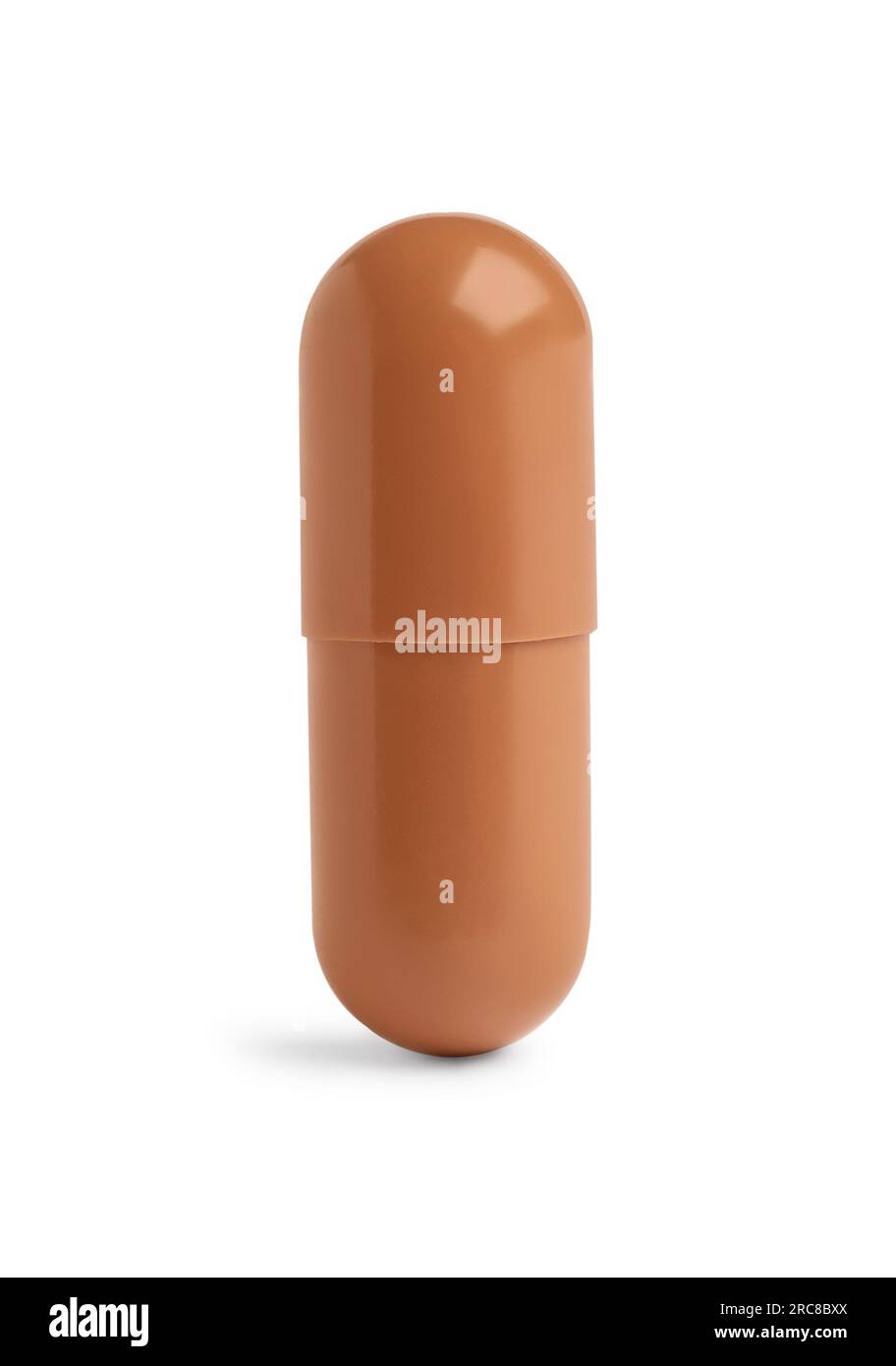 One brown pill on white background. Medicinal treatment Stock Photo - Alamy