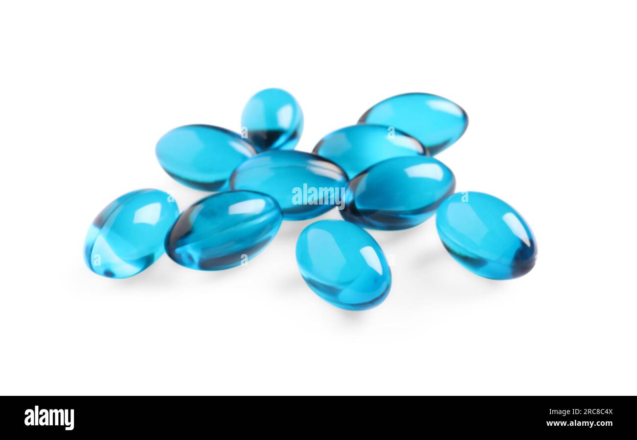 Many light blue pills isolated on white. Medicinal treatment Stock ...