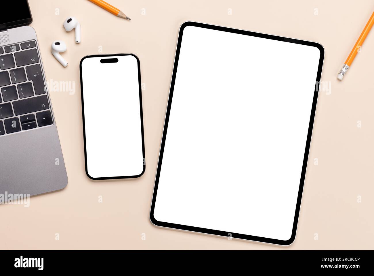 Blank white screen smartphone and tablet on a desk, perfect for your ...