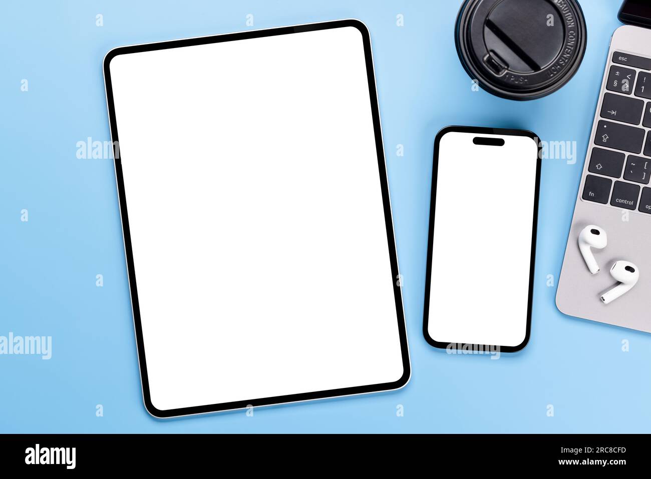 Blank white screen smartphone and tablet on a desk, perfect for your ...