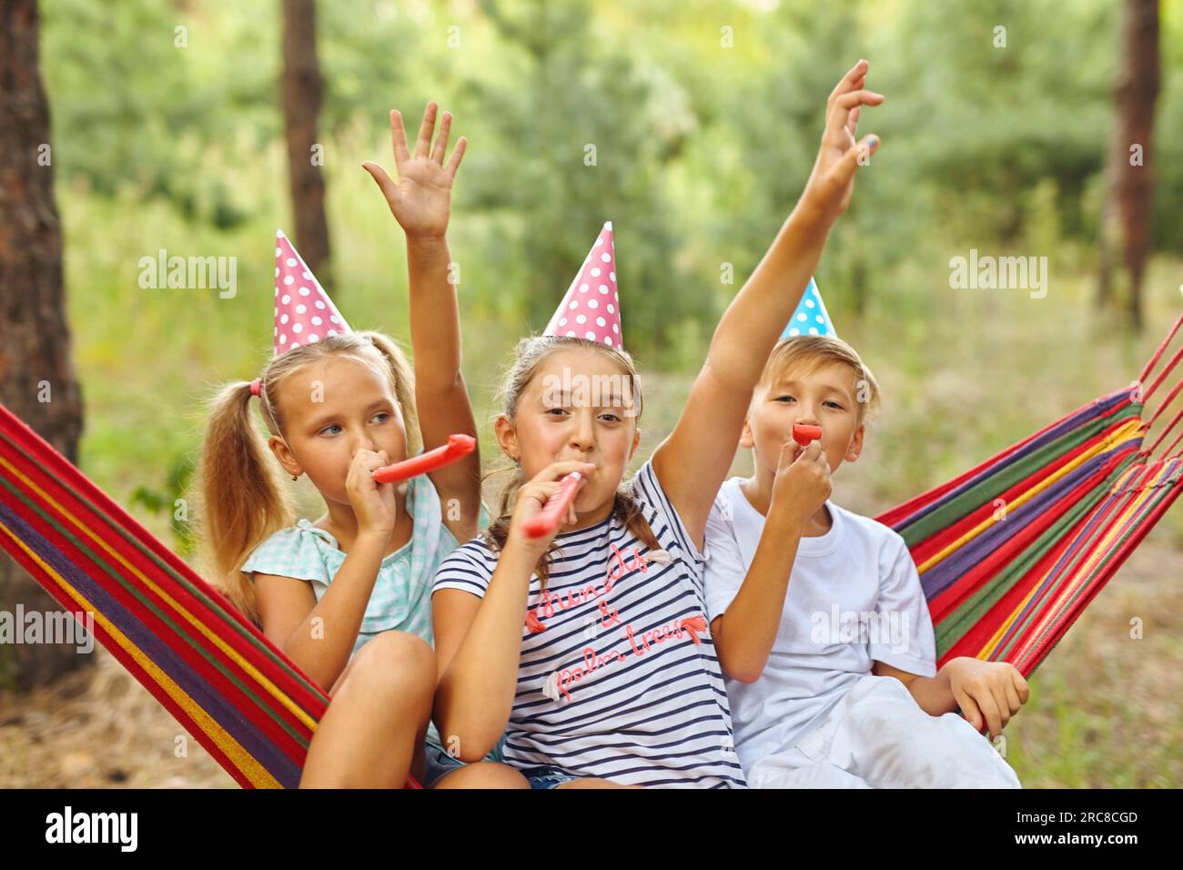 birthday, childhood and celebration concept - happy kids blowing party ...