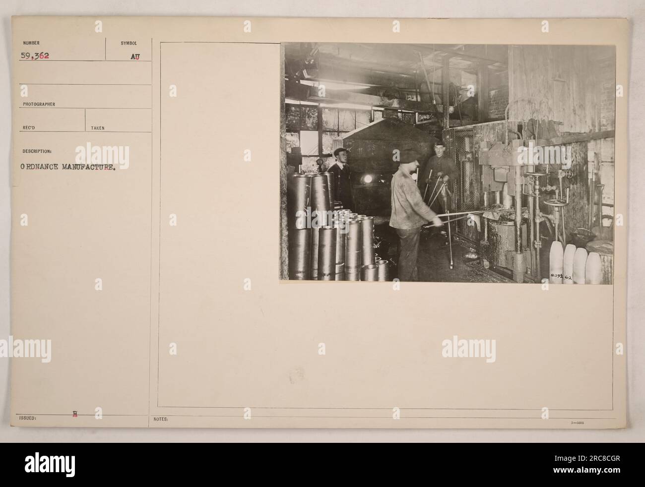 Soldiers working in an ordnance manufacturing facility during World War ...