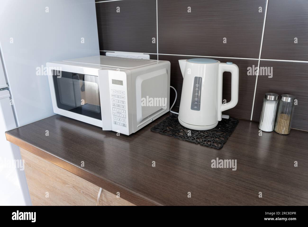Kitchen countertop with microwave and electric kettle Stock Photo - Alamy