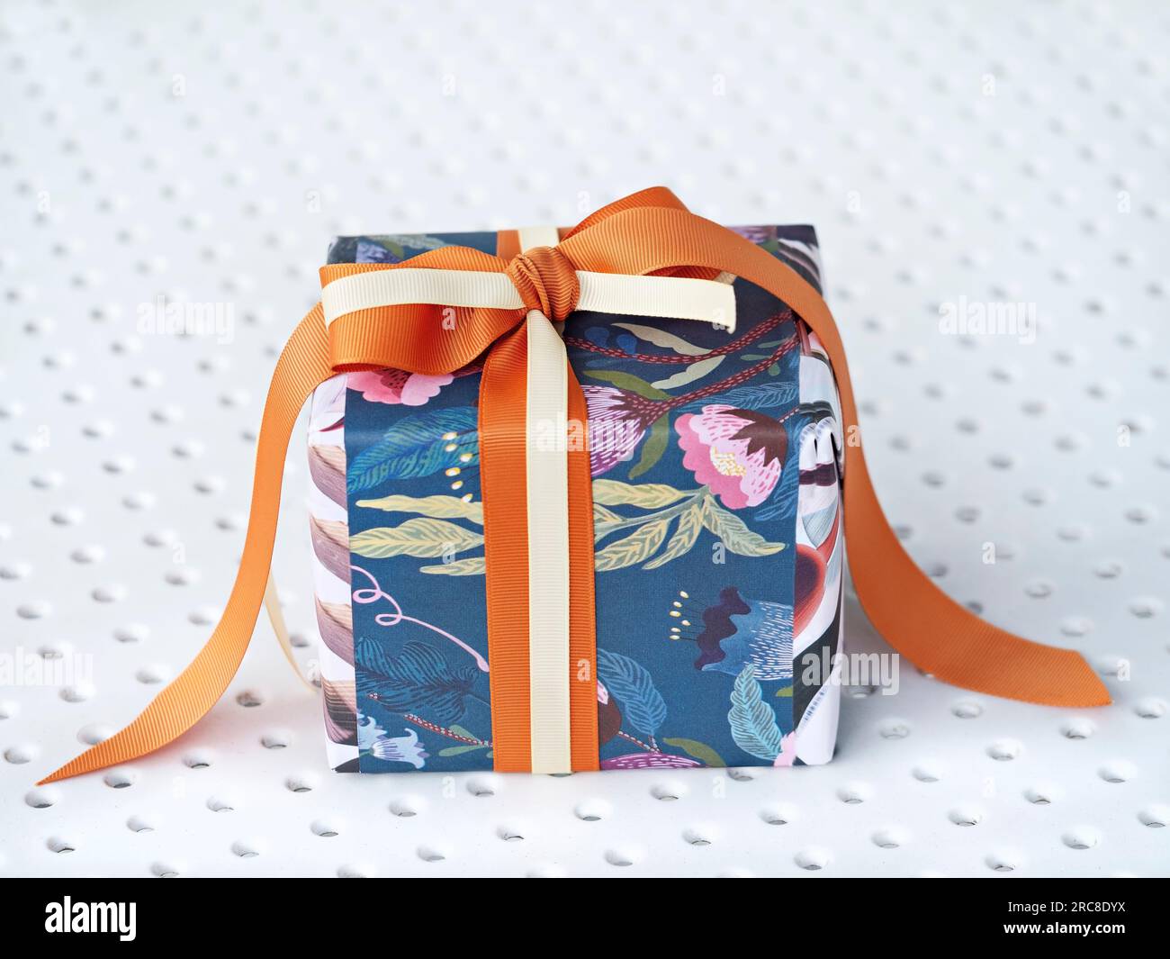Gifts / A home wrapped gift tied with a ribbon Stock Photo - Alamy