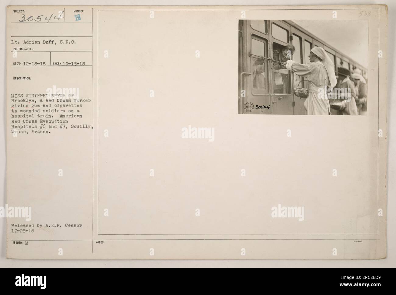 Red Cross worker, Miss Winifred Bryce, providing gum and cigarettes to ...