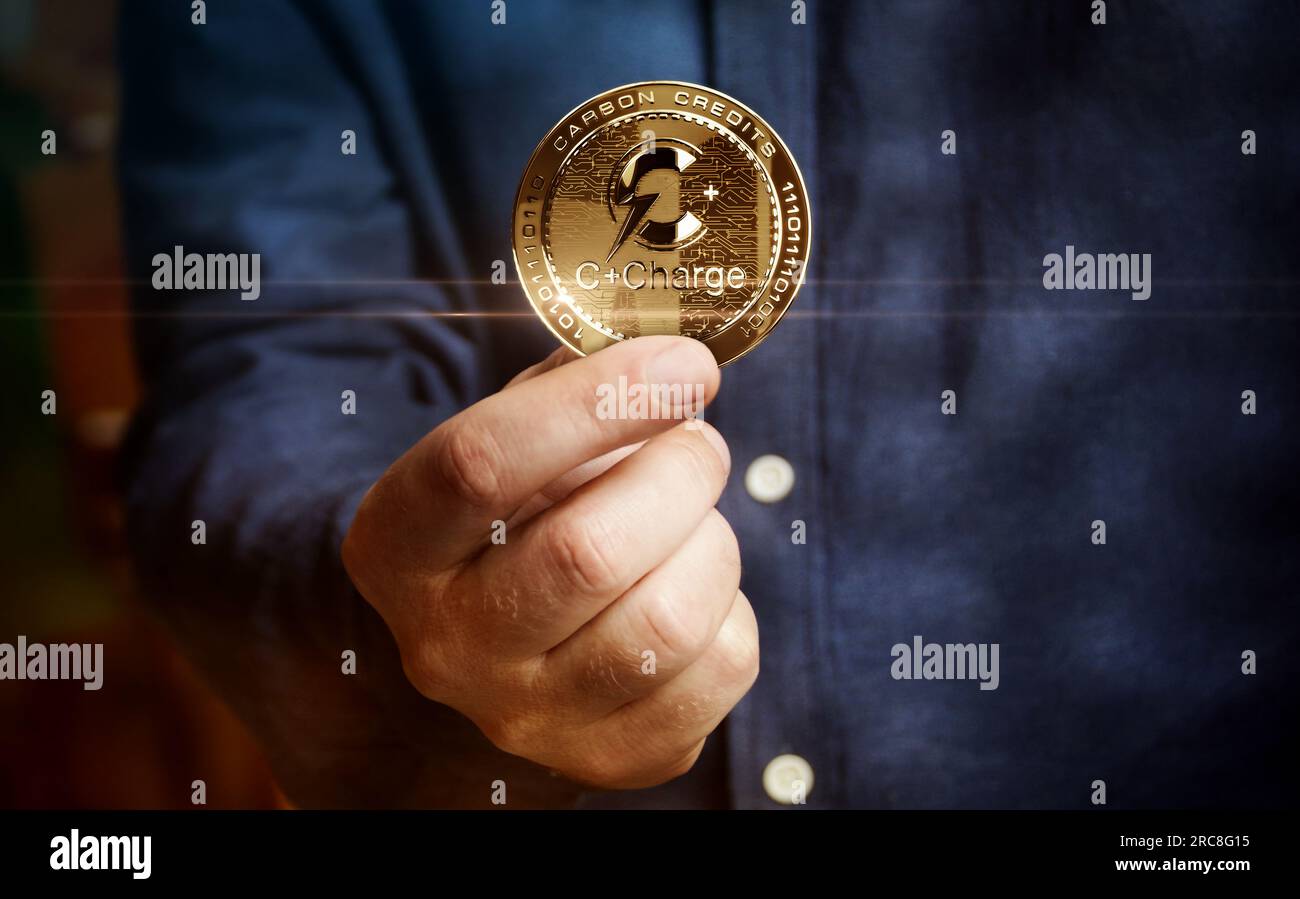 C Charge CCHG EV crypto EV fuel CCharge golden coin in hand abstract ...