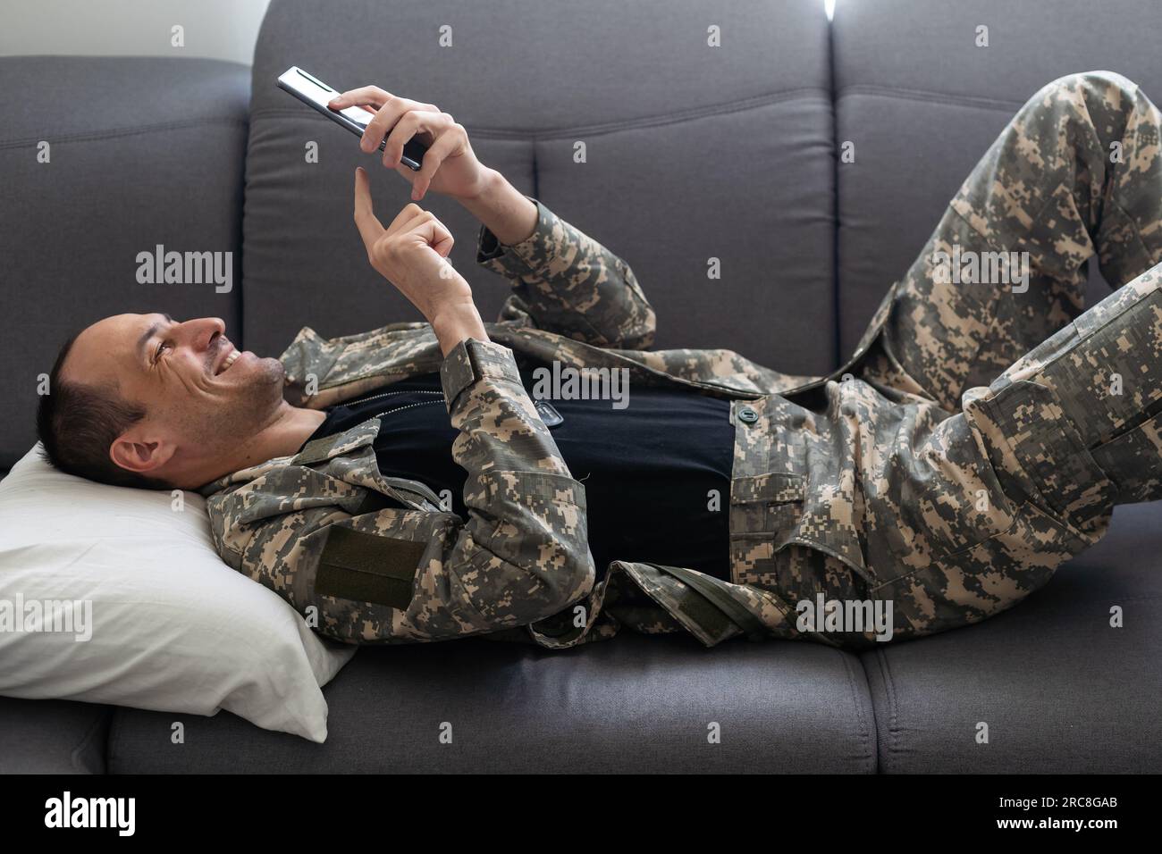 Sitting holding smiling communication army soldier hi-res stock ...