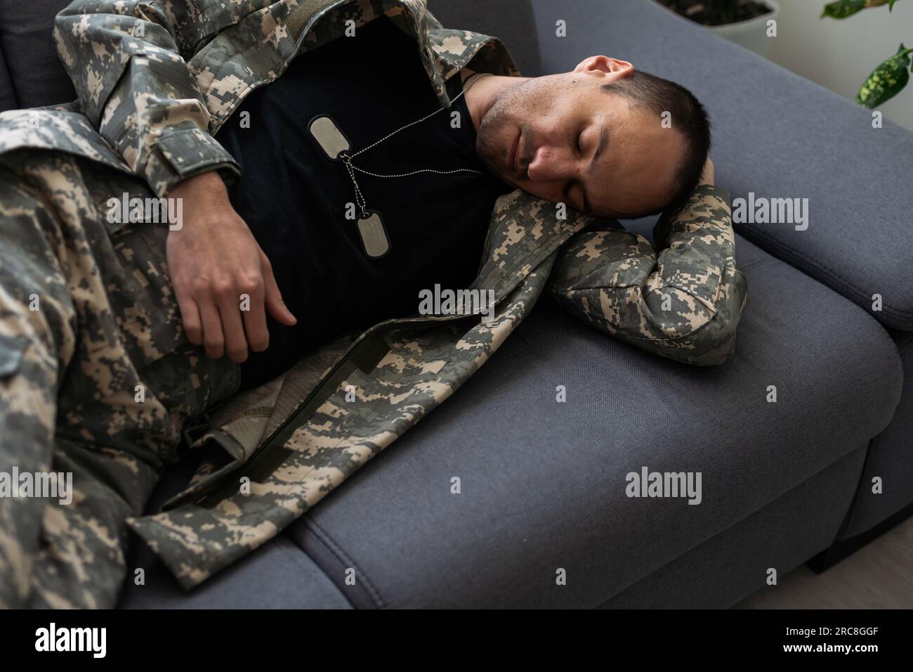 Tired military man sleeping on couch at home Stock Photo - Alamy