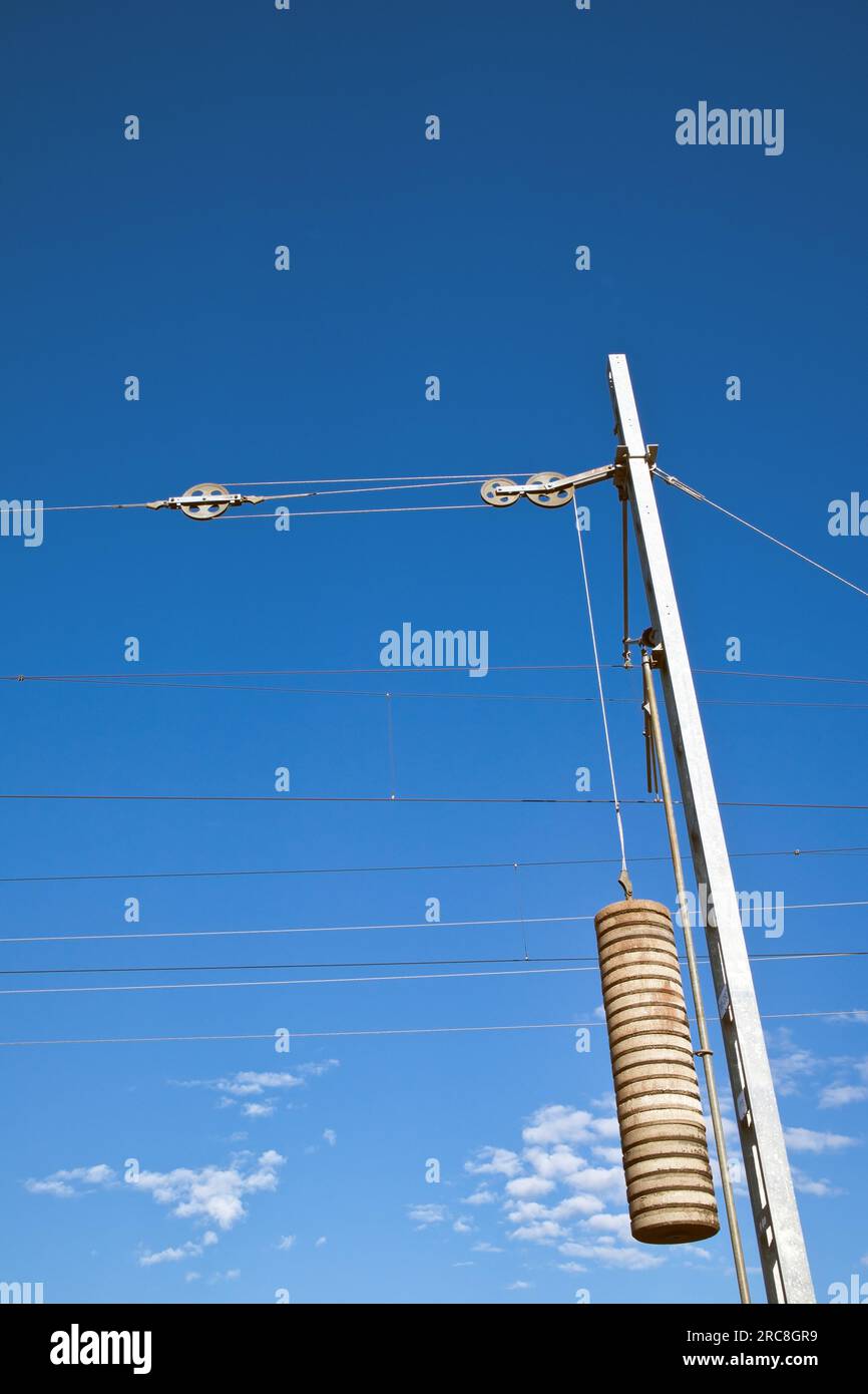 Railroad switch counter weight mechanism against blue sky Stock Photo ...