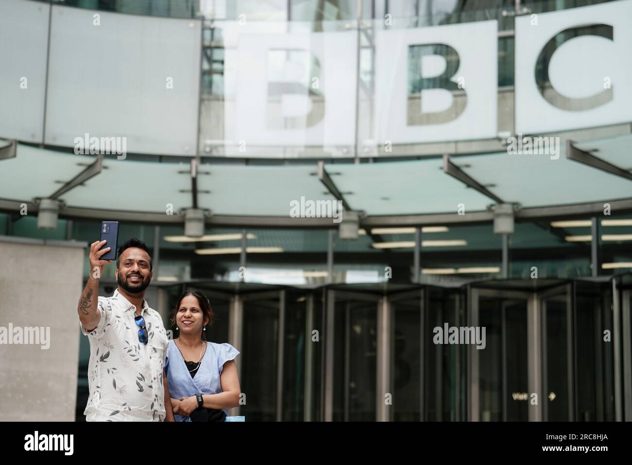 A couple take a selfie outside BBC Broadcasting house, in central London, after presenter Huw ...