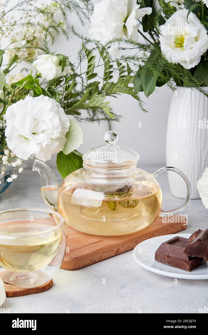 Aesthetic tea time, teapot, green tea and chocolate in biophilic ...