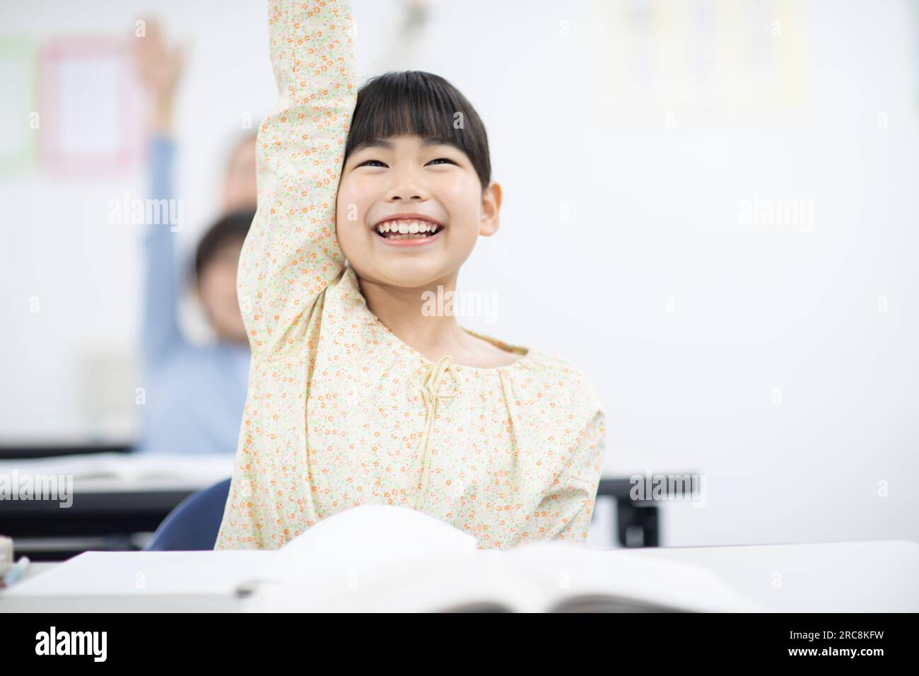 School girl raises hand hi-res stock photography and images - Alamy