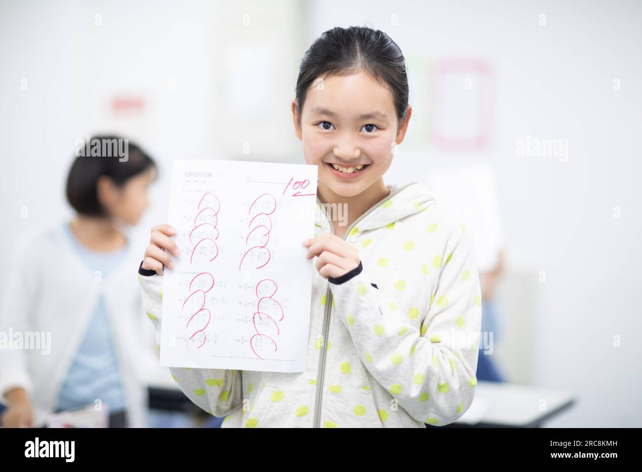 Elementary school student holding test and smiling Stock Photo - Alamy
