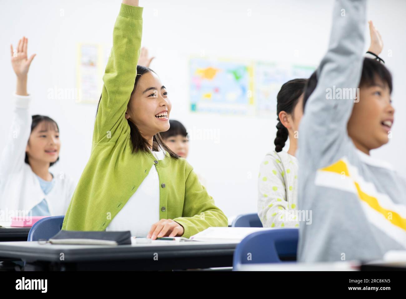 Girl raising her hand cheerfully Stock Photo - Alamy