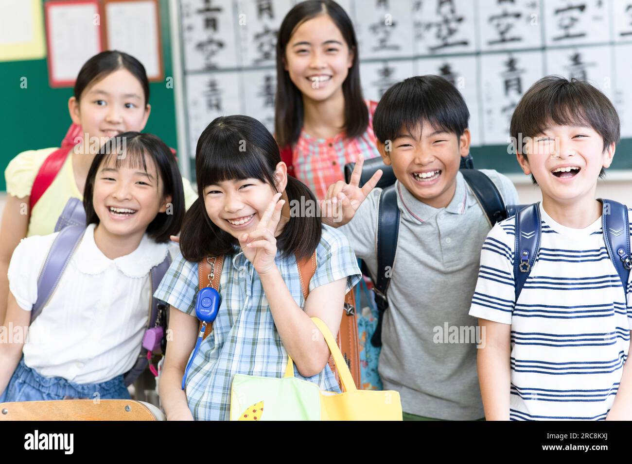 Smiling elementary school students in class Stock Photo - Alamy