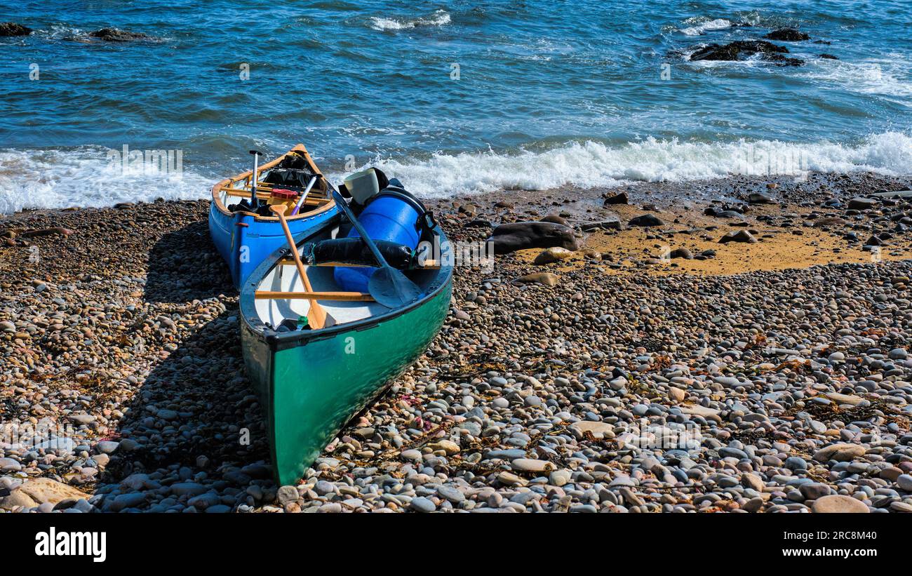 Open Canadian canoes kitted out and beached on a shingle shore Stock ...