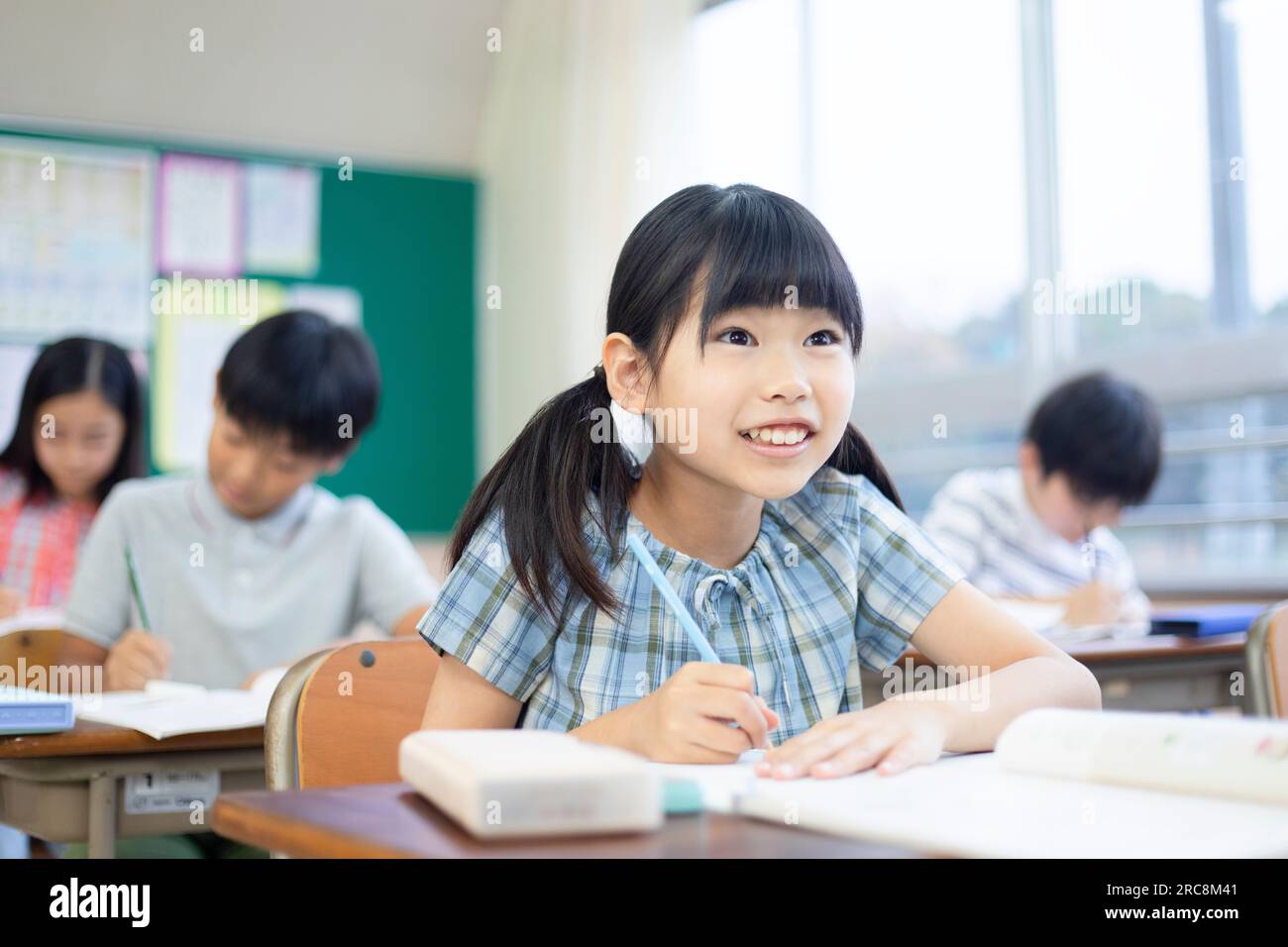 An elementary school student studying during class Stock Photo - Alamy
