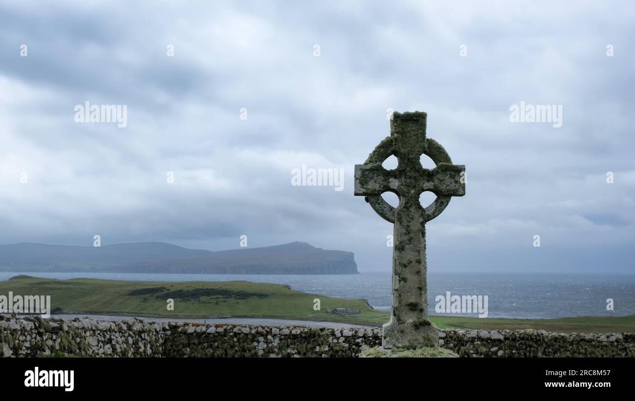 Celtic cross in Trumpan Church graveyard and Dunvegan Head Stock Photo ...