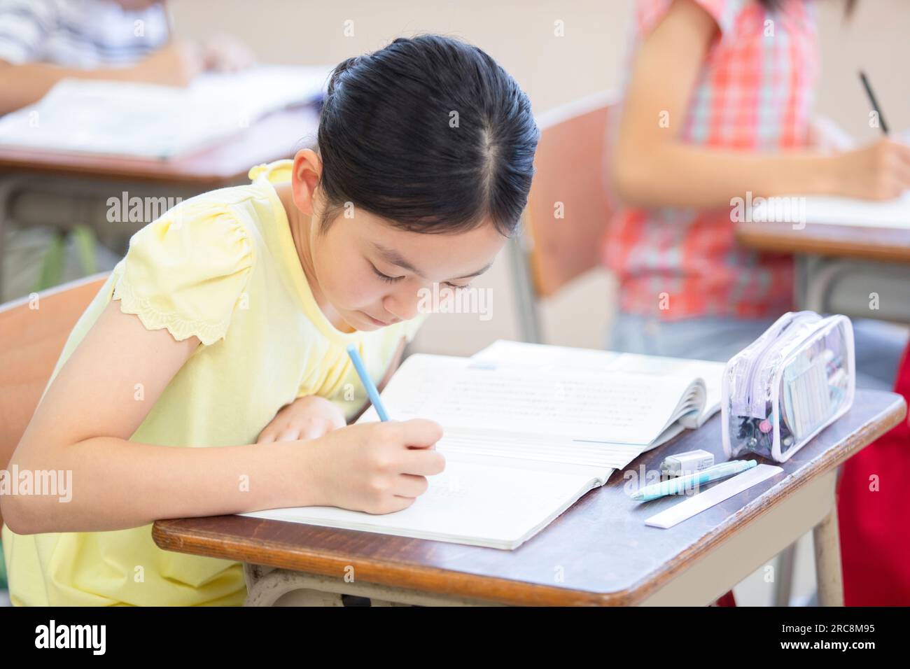 Elementary school students studying during class Stock Photo - Alamy