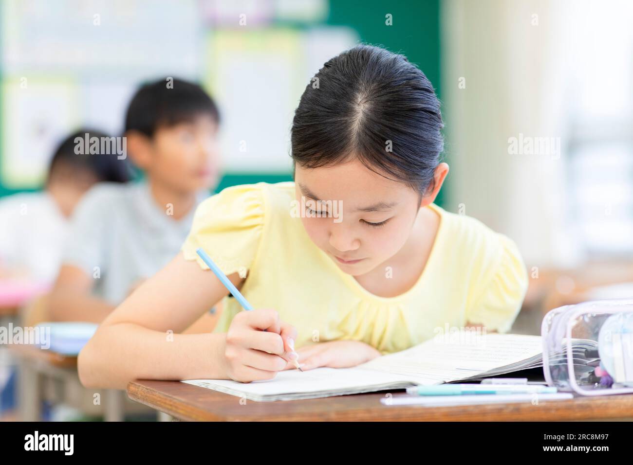 An elementary school student studying during class Stock Photo - Alamy
