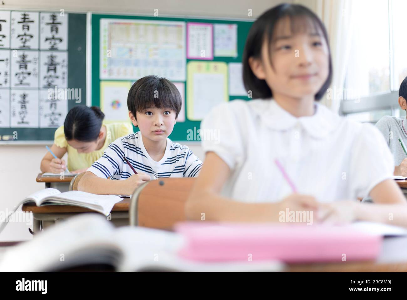 An elementary school student studying during class Stock Photo - Alamy