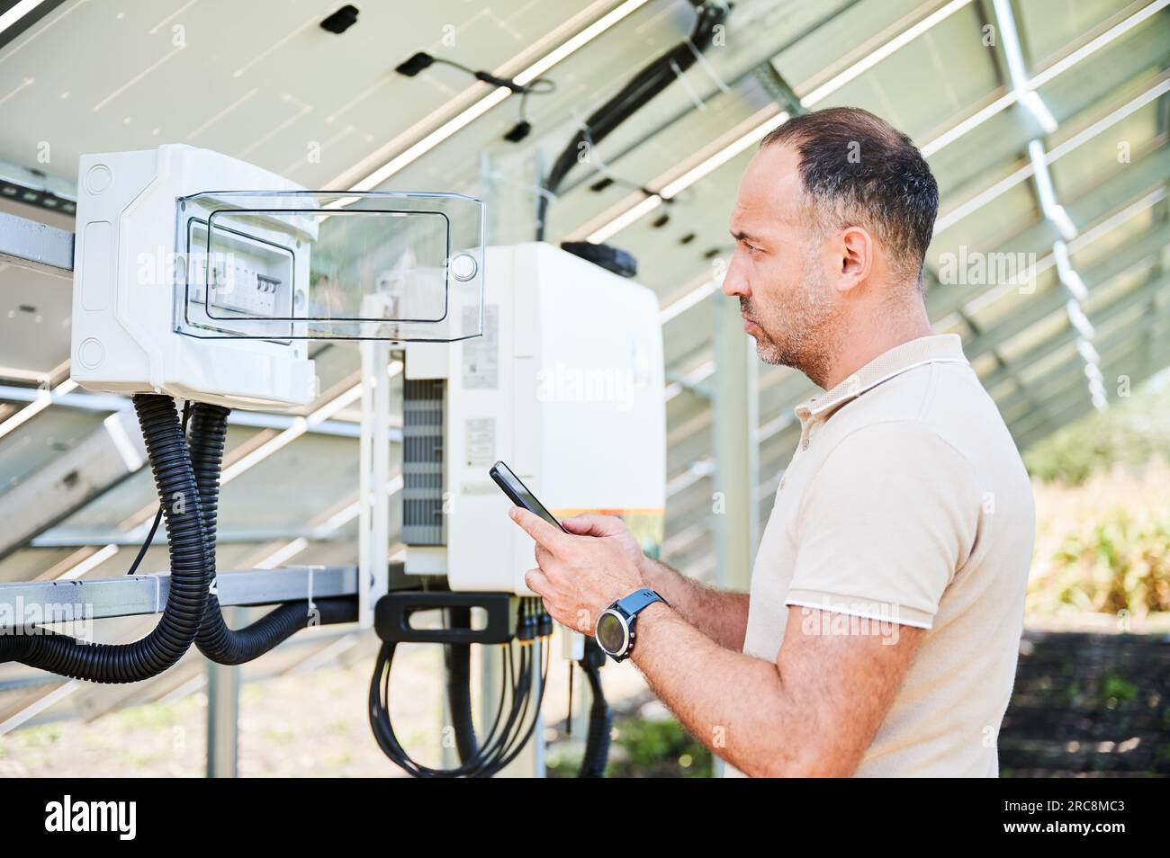 Configuring of photovoltaic solar battery. Man turning on switches ...