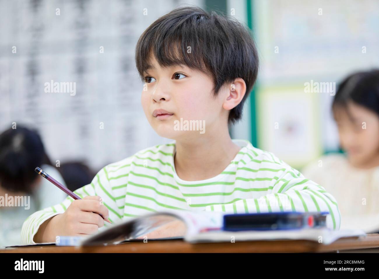 Elementary school student studying during class Stock Photo - Alamy