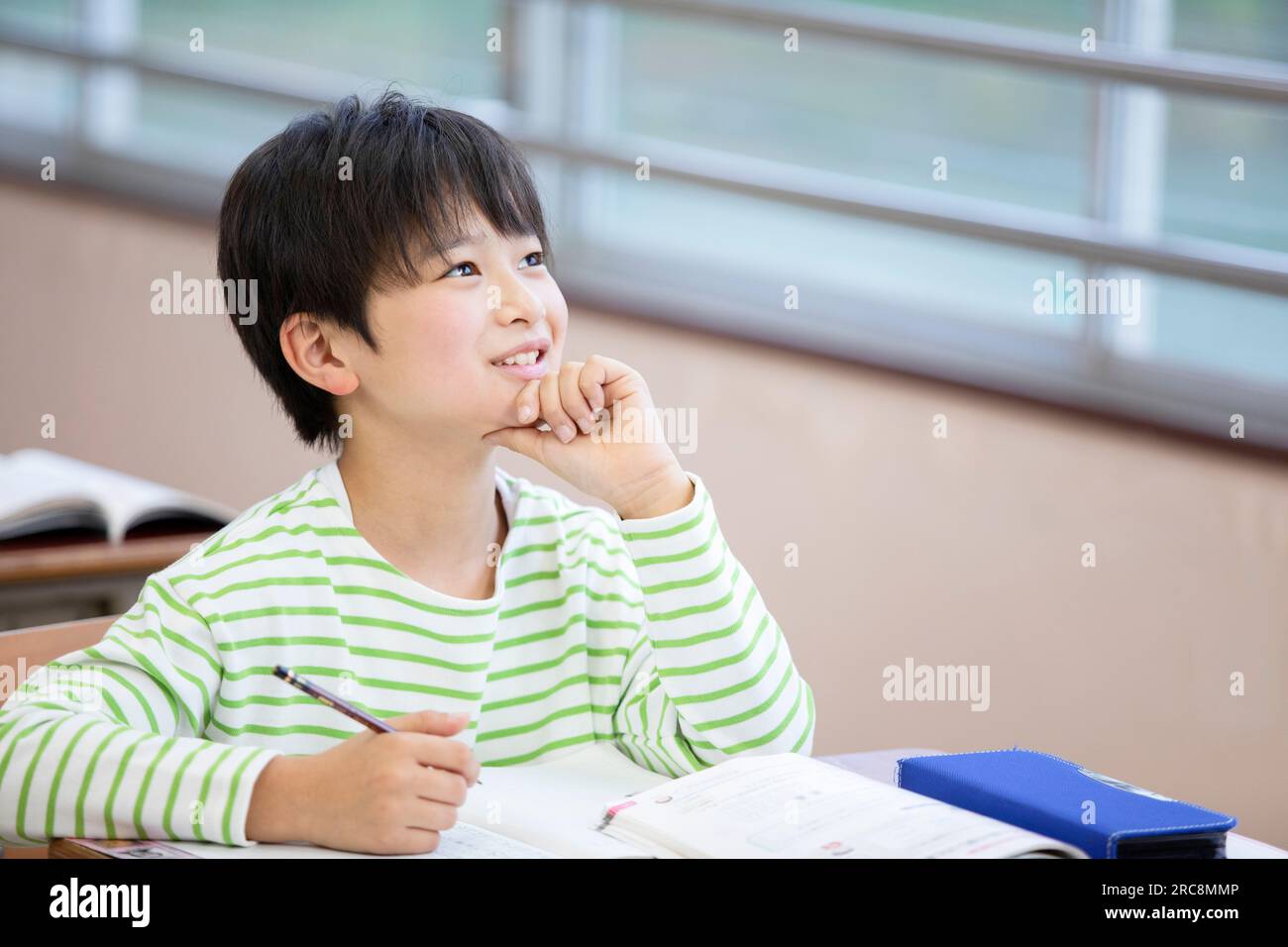 Elementary school student thinking during class Stock Photo - Alamy