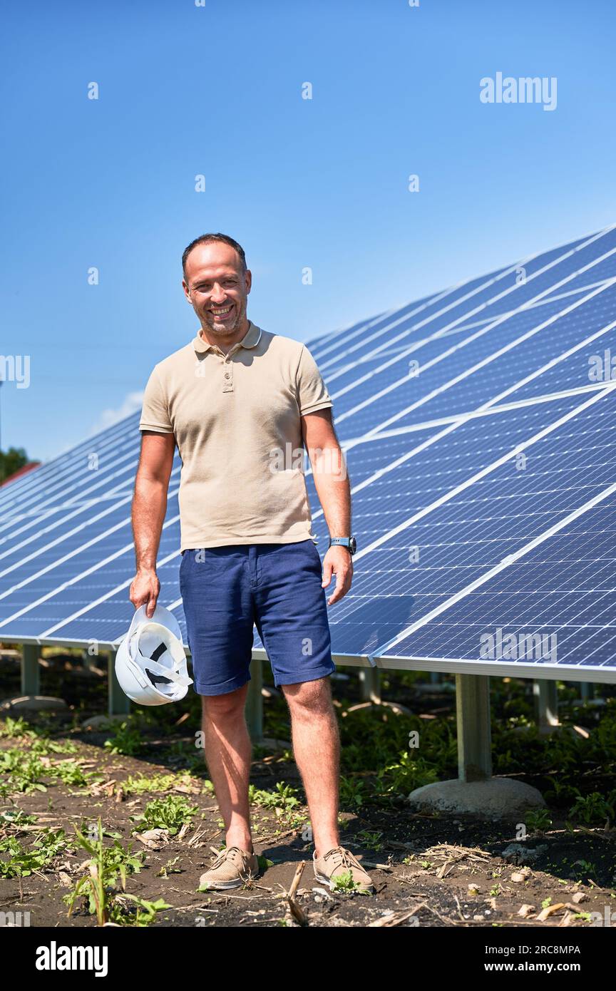 Solar panels maintenance. Young man checking PV batteries. Maln with ...