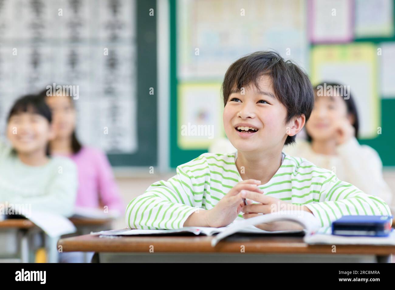 Elementary school students studying during class Stock Photo - Alamy