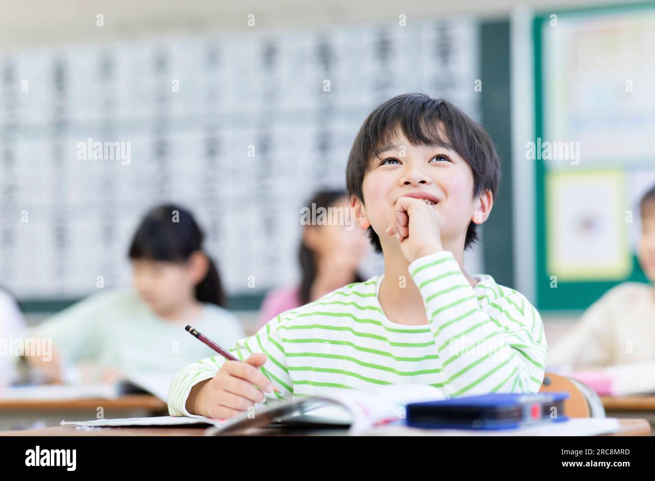 Elementary school students studying during class Stock Photo - Alamy