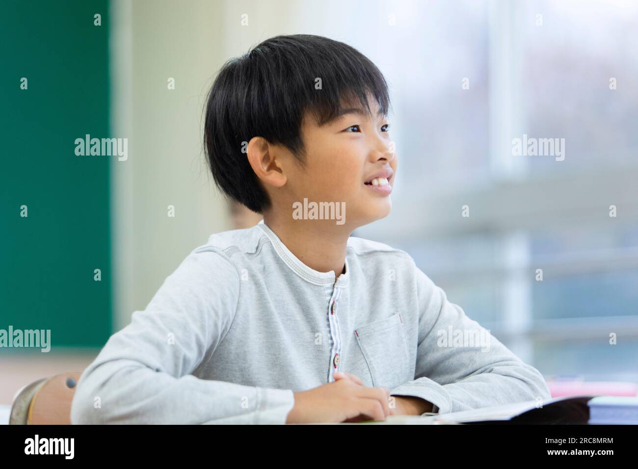 An elementary school student studying during class Stock Photo - Alamy