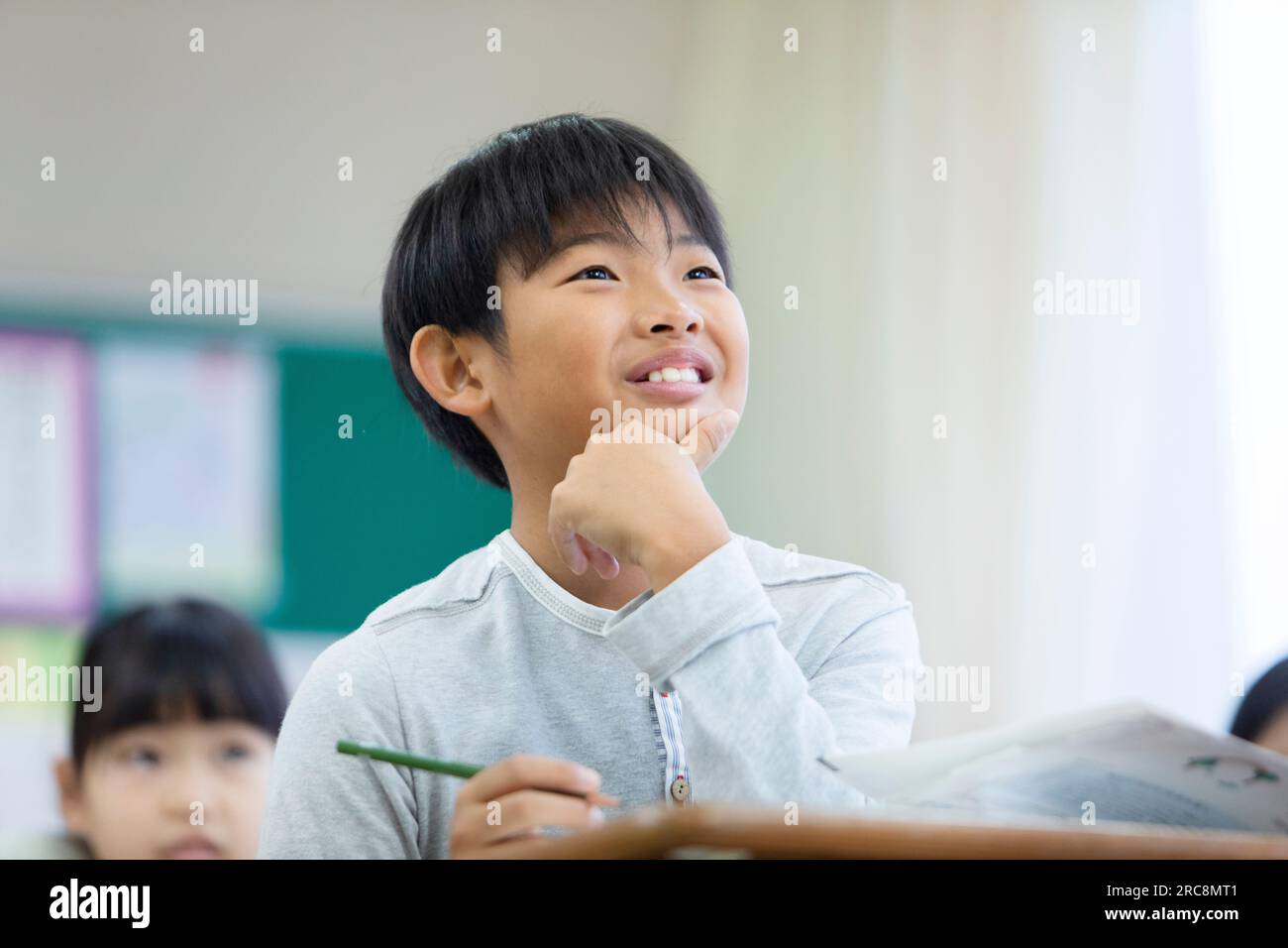 Elementary school students studying during class Stock Photo - Alamy