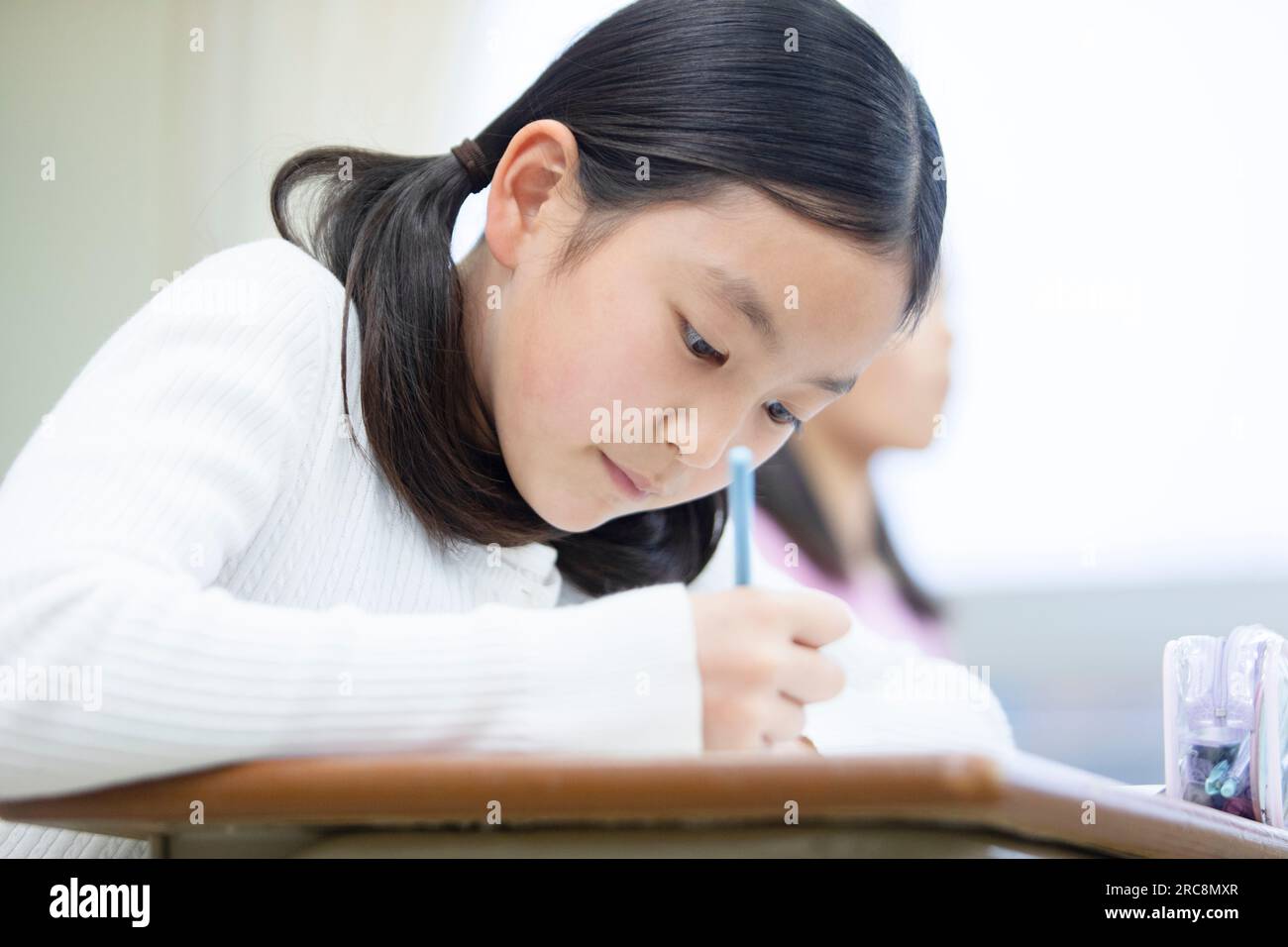 An elementary school student studying during class Stock Photo - Alamy