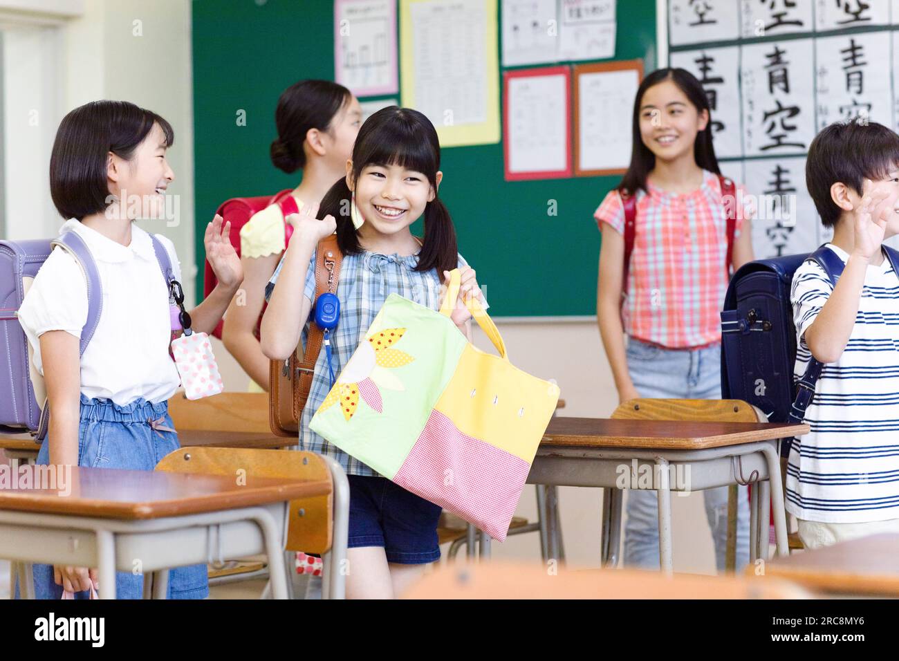 Elementary school students taking their seats after arriving at school ...