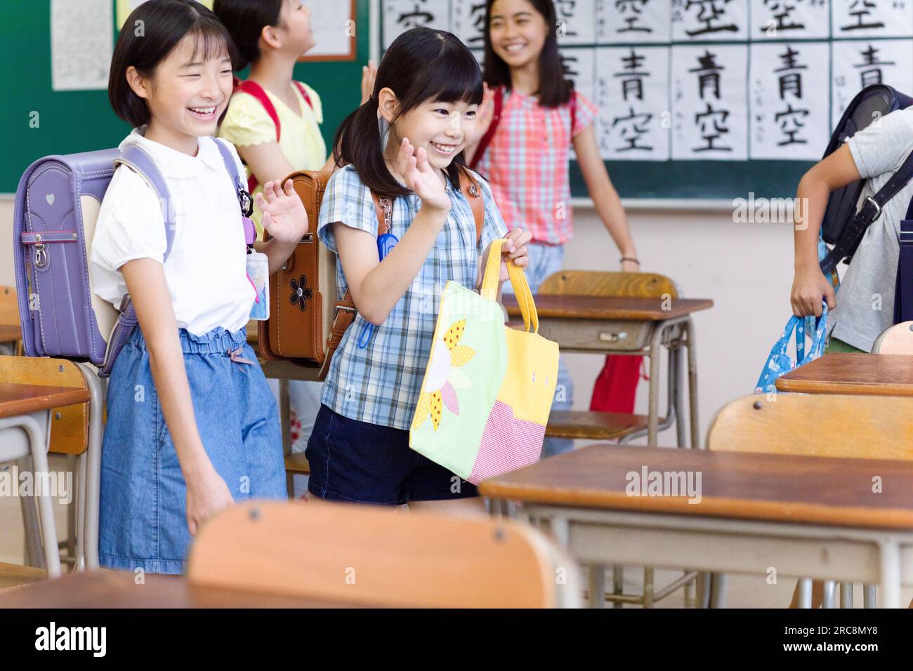 Elementary school students arriving at school and taking their seats ...
