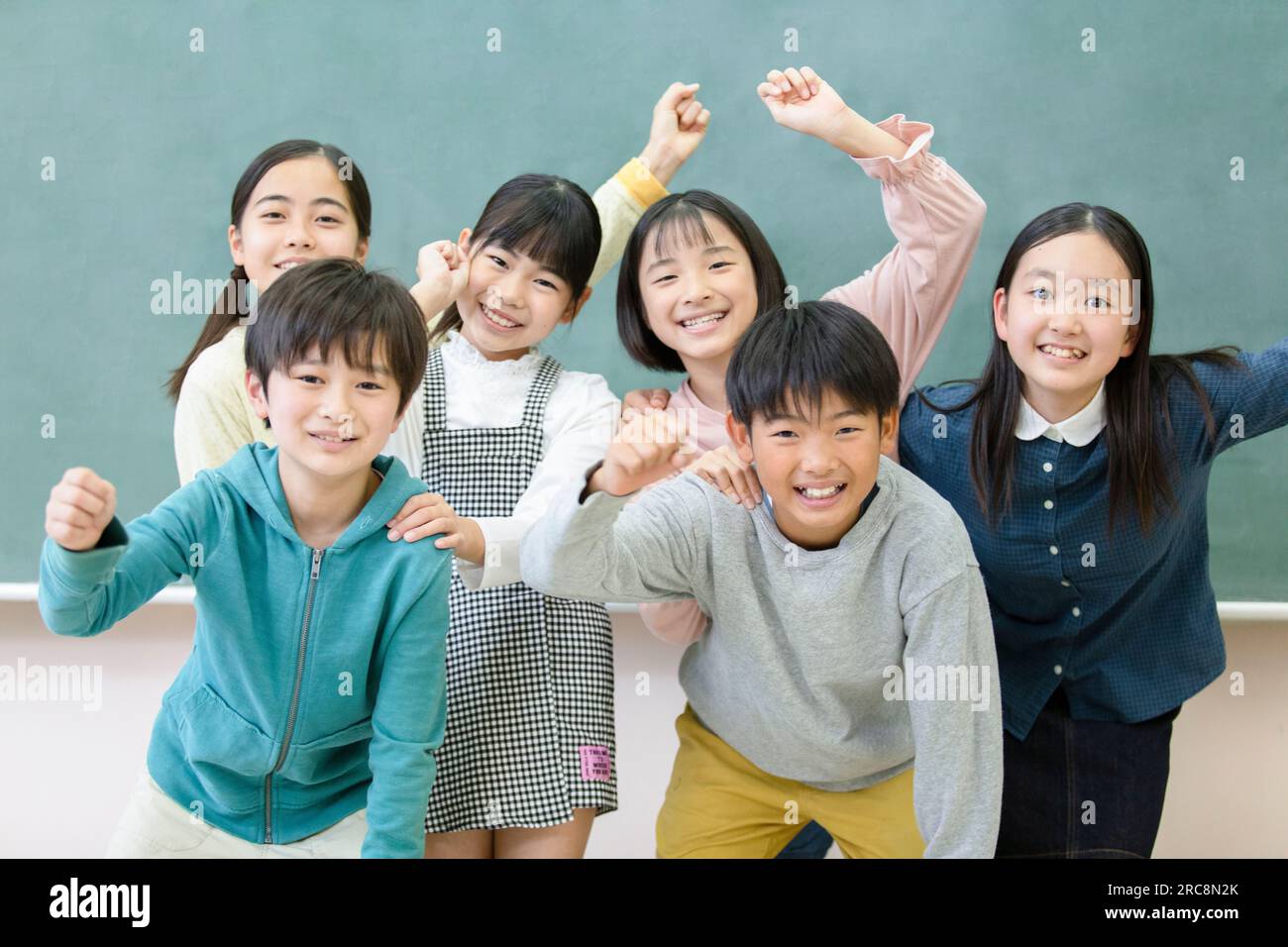 Elementary school children playing in front of the blackboard Stock ...